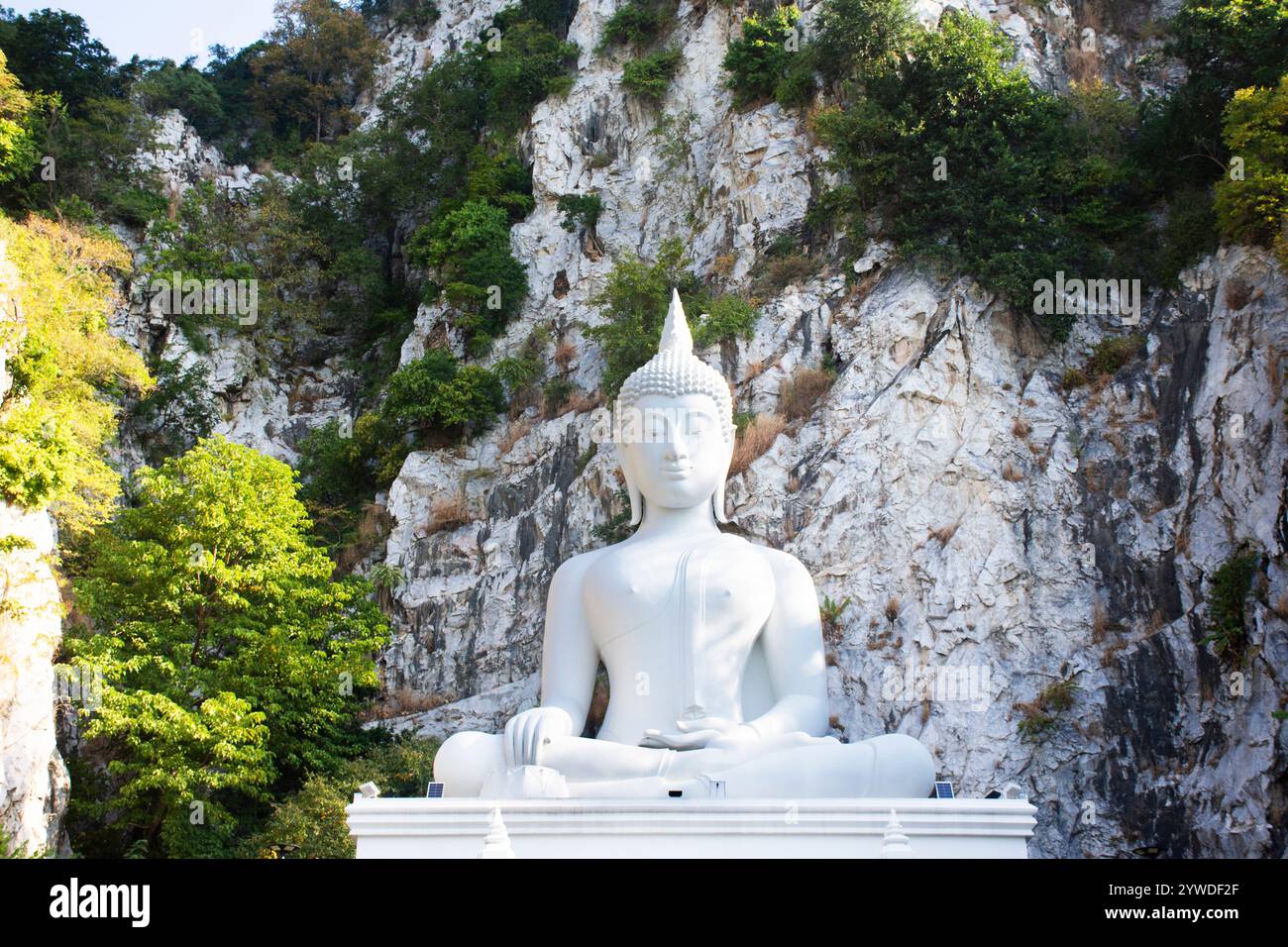White holy buddha ancient statue on mountain in forest for thai people ...