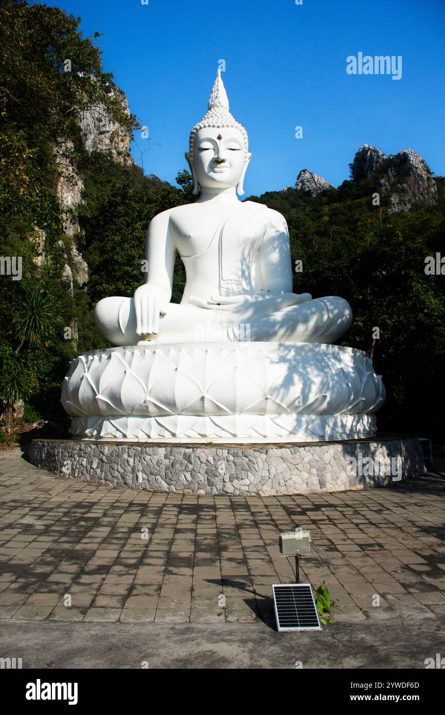 White holy buddha ancient statue on mountain in forest for thai people ...