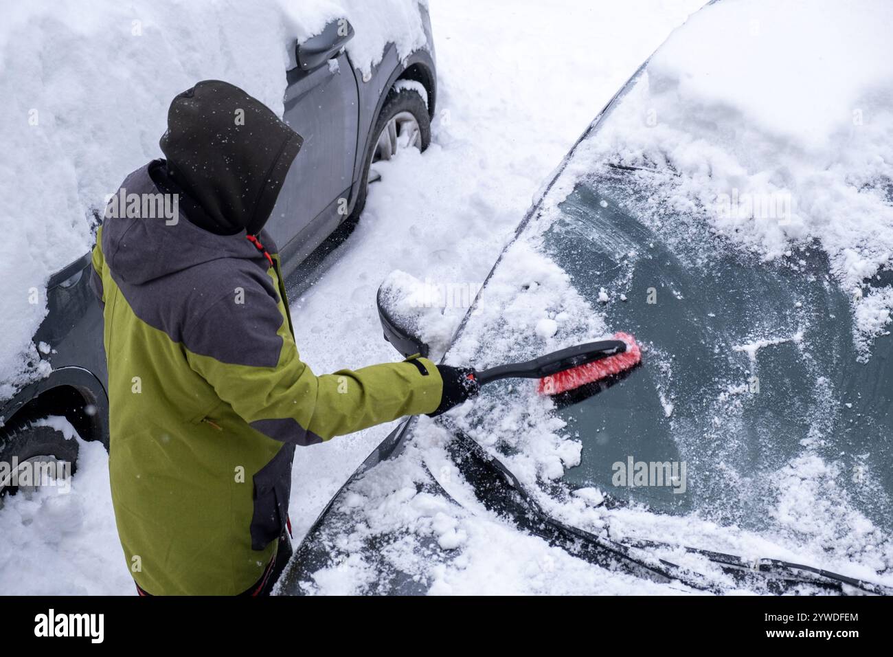 Person Clearing Snow from Car in Winter Landscape Stock Photo - Alamy