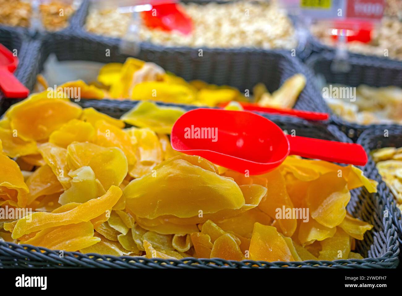 dried mango pieces in a container in a supermarket. Healthy food Stock ...