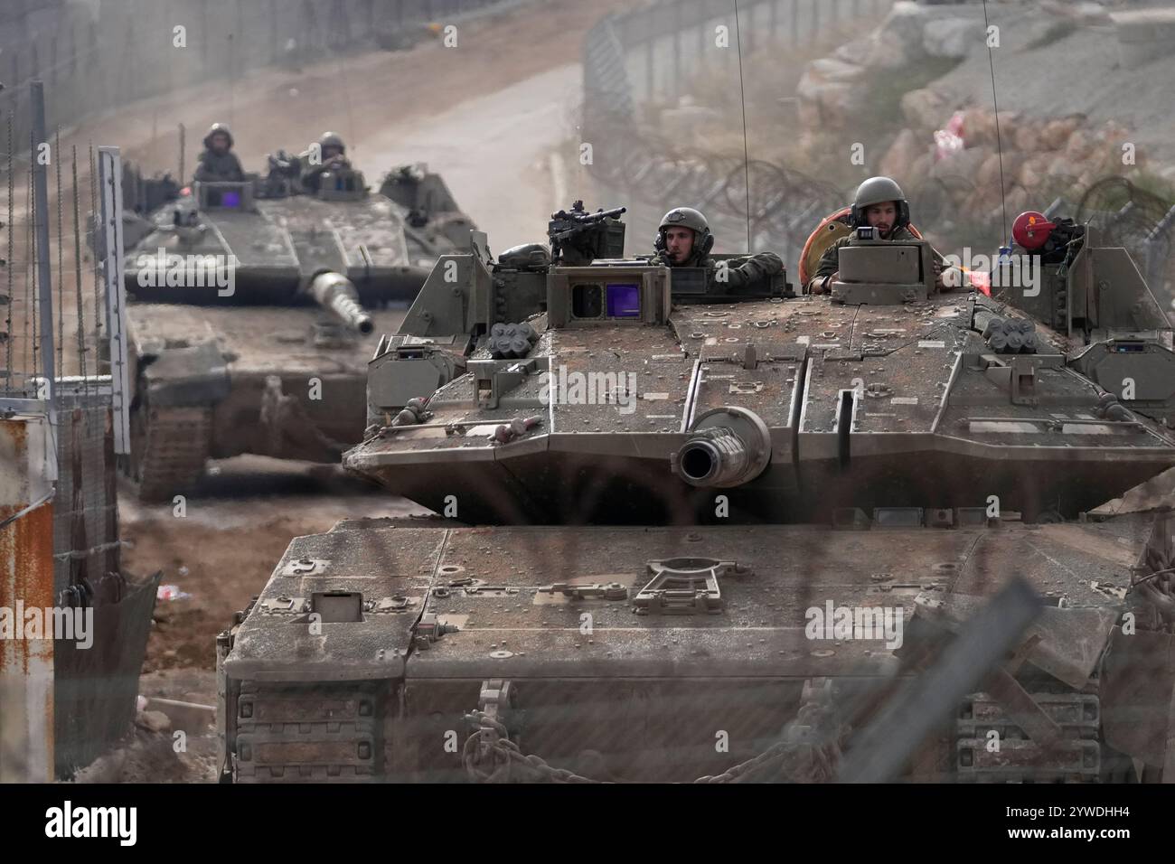 Israeli army tanks maneuver near the so-called Alpha Line that ...
