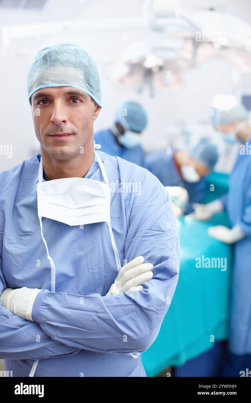 Arms crossed, surgery and teamwork with man in theatre for doctors ...