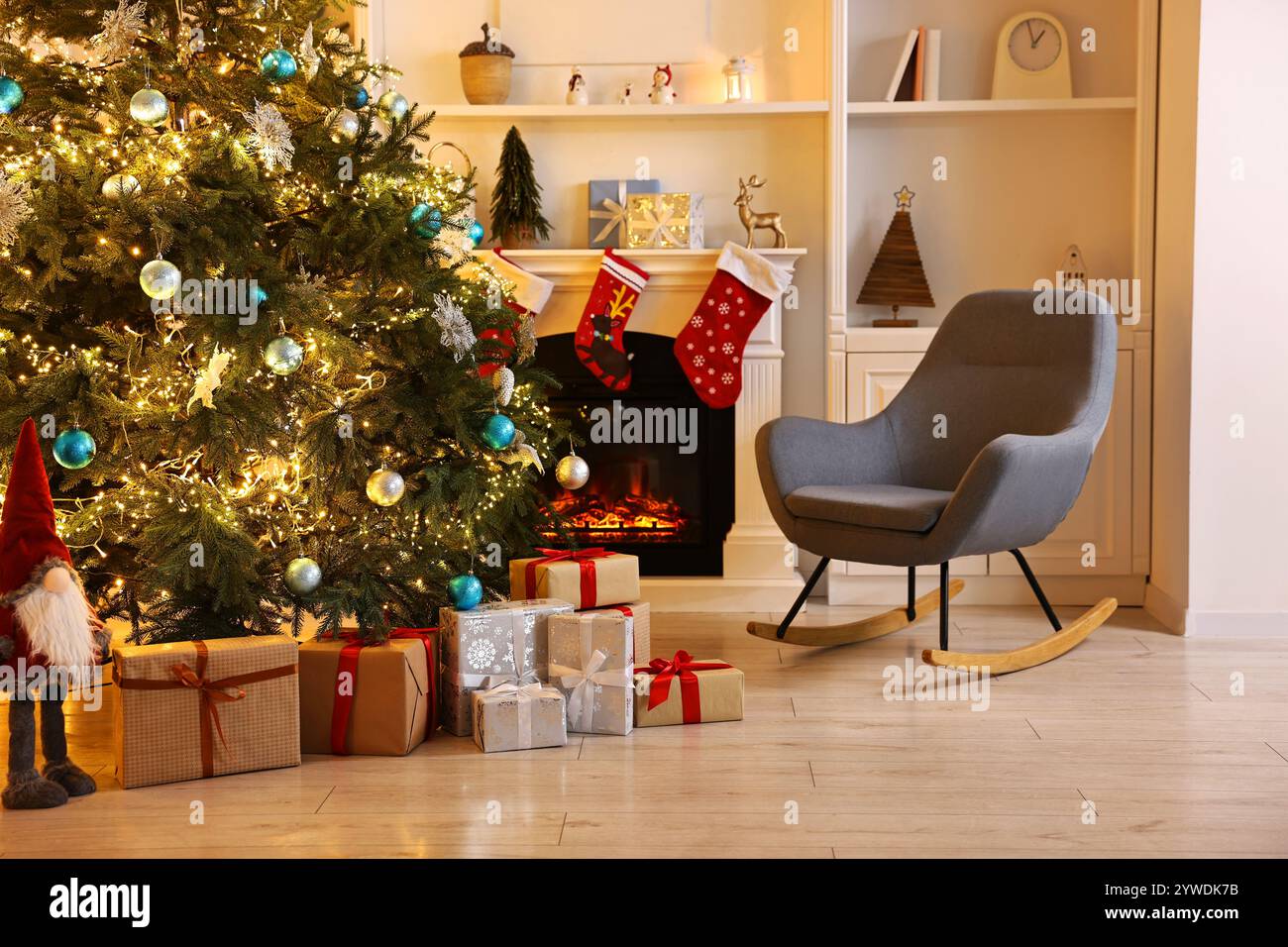 Christmas tree and rocking chair near decorated fireplace in room ...