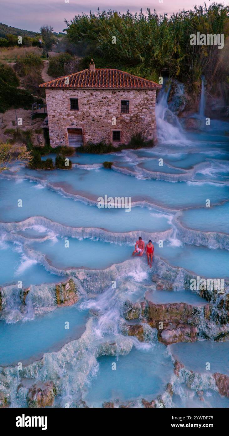 Visitors unwind in the soothing thermal waters of Saturnia, surrounded ...