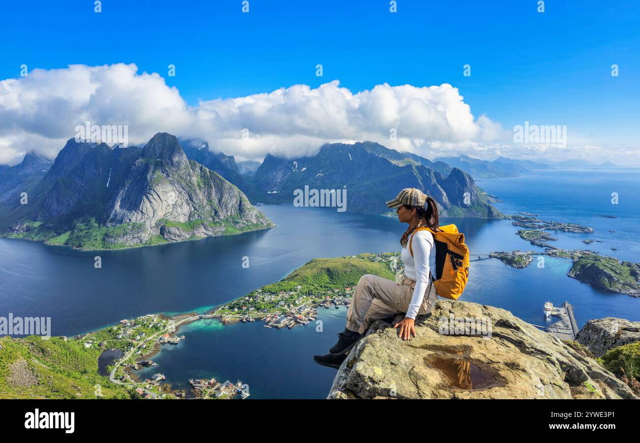 An Asian woman perches on a rocky ledge, gazing across the stunning ...