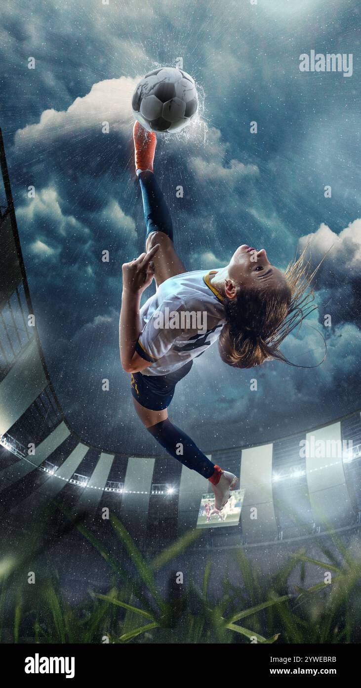 Female soccer player in action, executing an overhead kick towards ball in dramatic rainy ...