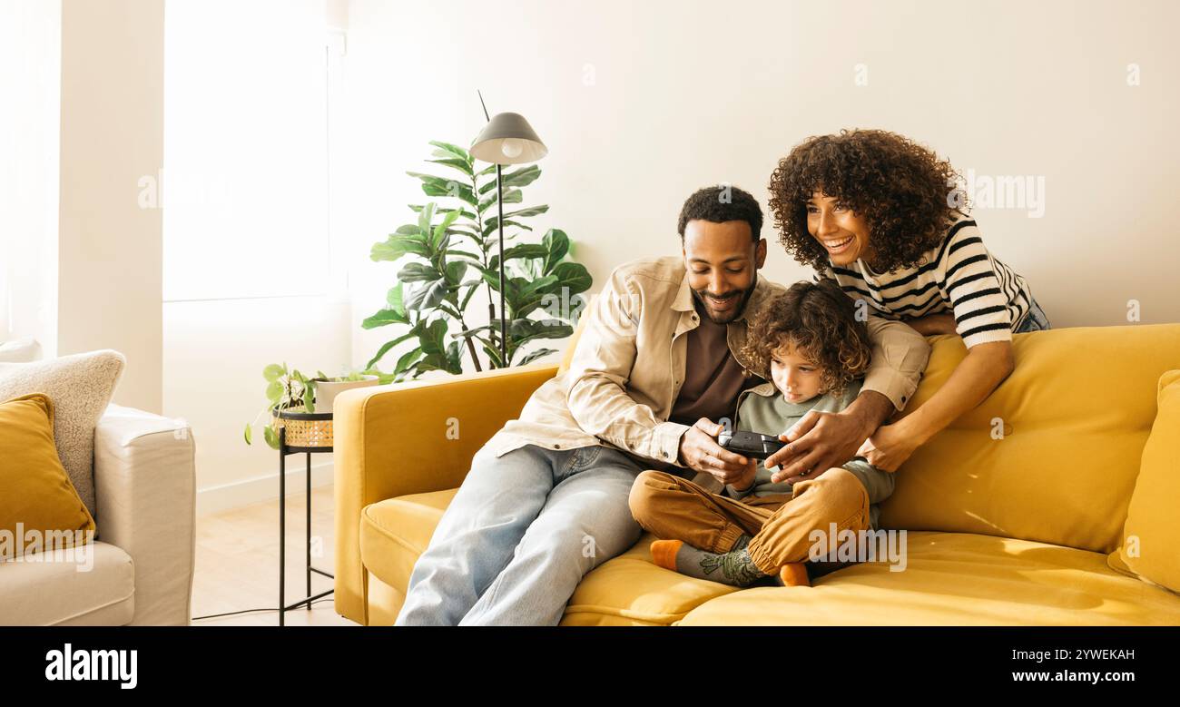 Smiling parents and their young child enjoying a bonding moment on a ...