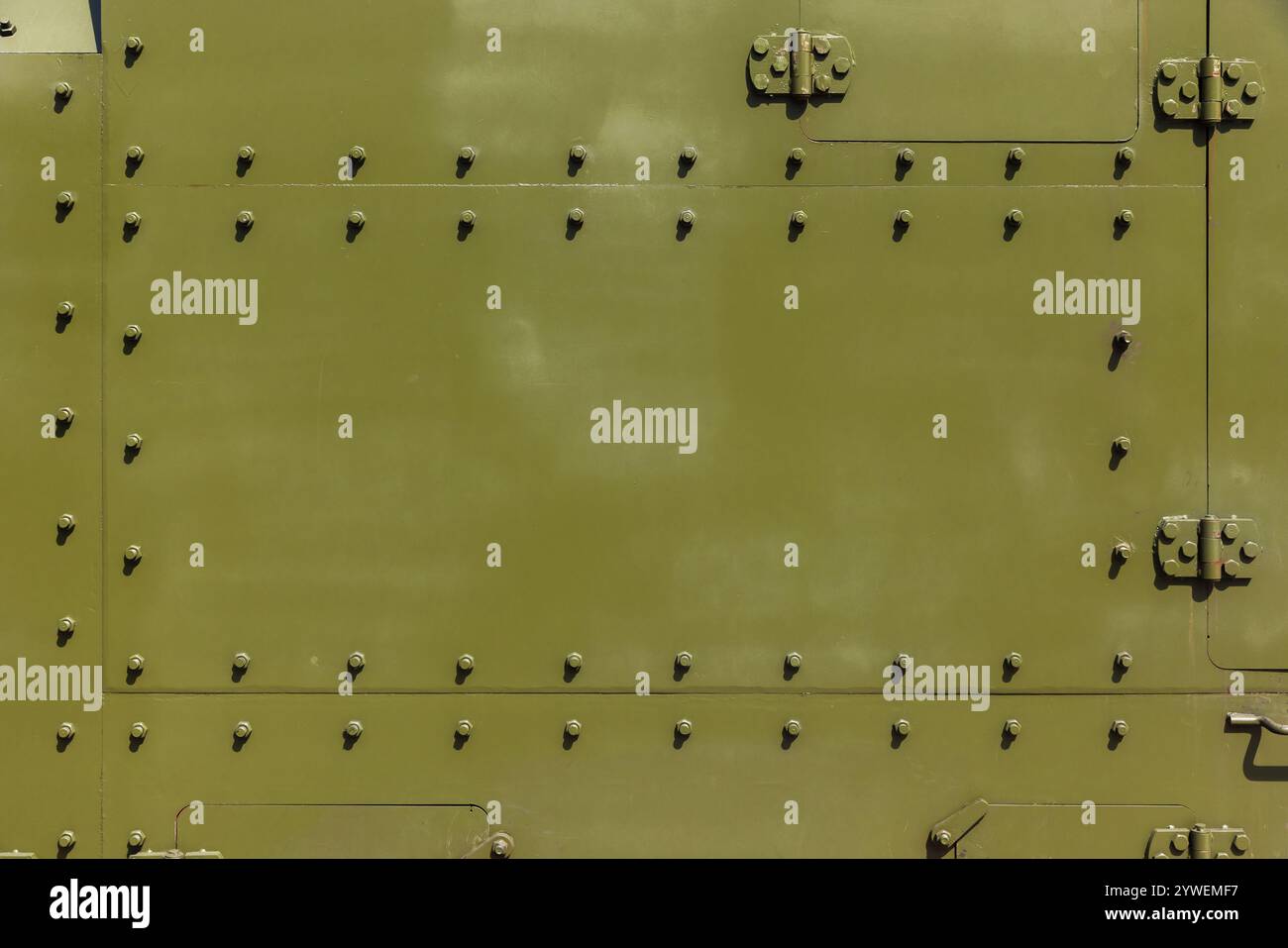 Abstract industrial background texture with bolts of khaki steel wall ...