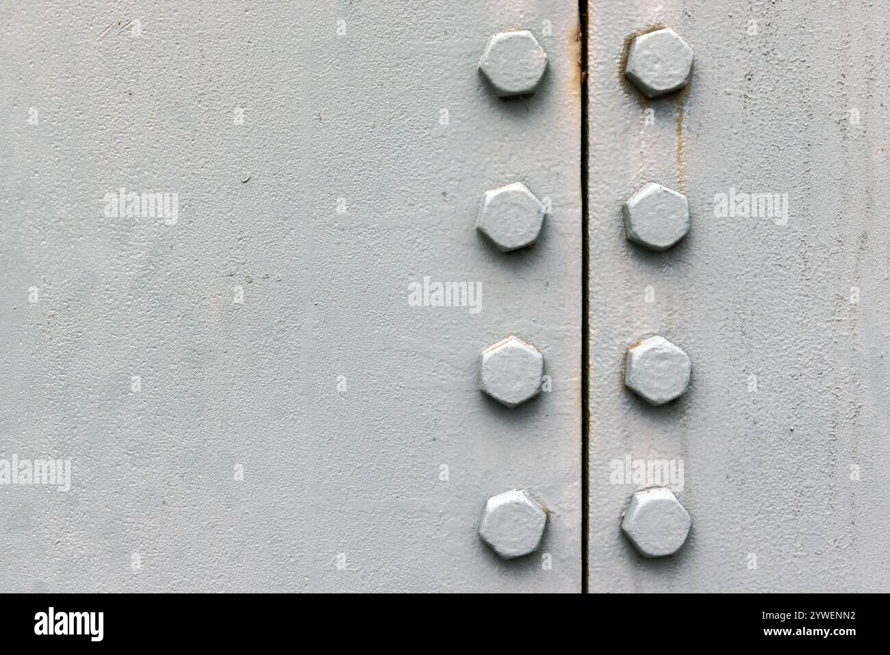 White steel wall with bolts, metal parts connection, close-up abstract ...
