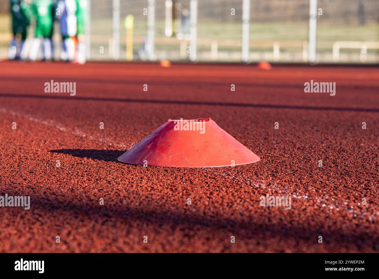 Cone for soccer training on tartan track Stock Photo - Alamy