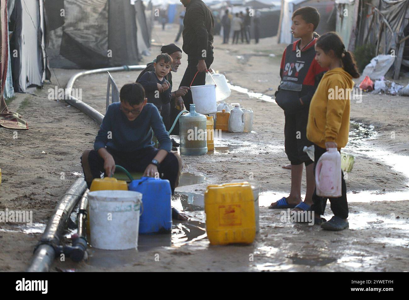 Children use the underground water line to obtain drinking water in ...