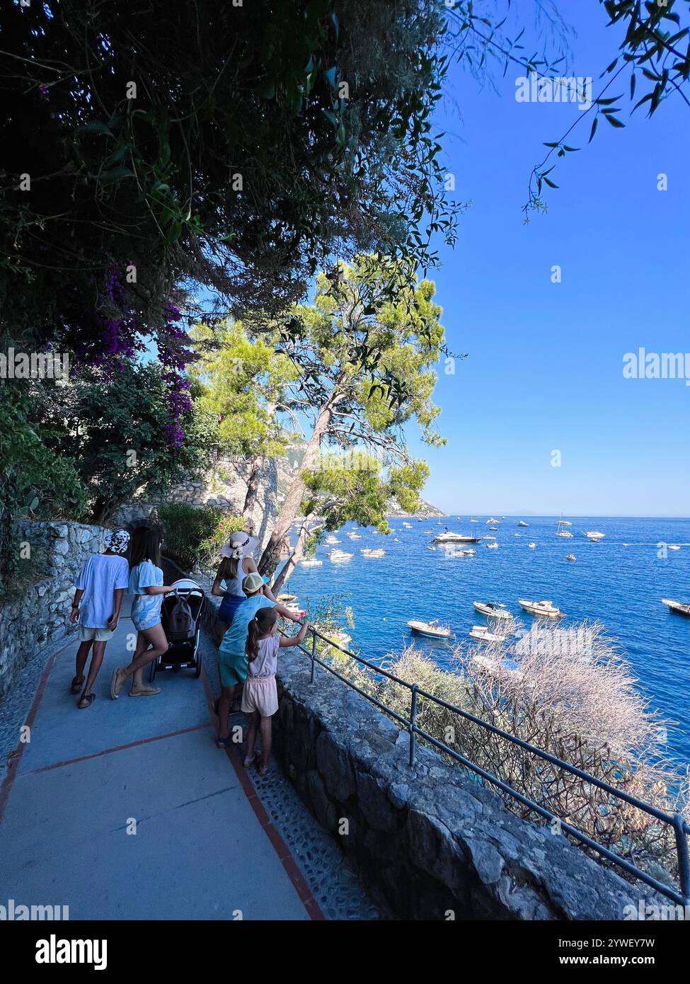 Family takes a leisurely along a picturesque coastal path, enjoying the ...