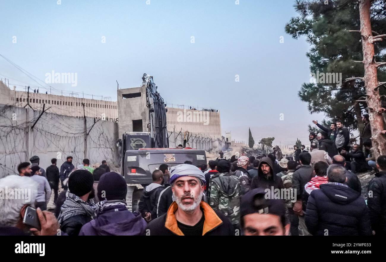 Syrian civil defence and the families of missing people seen searching ...