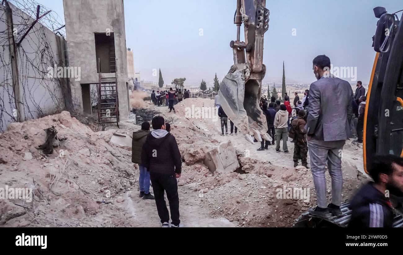 Syrian civil defence and the families of missing people seen searching ...