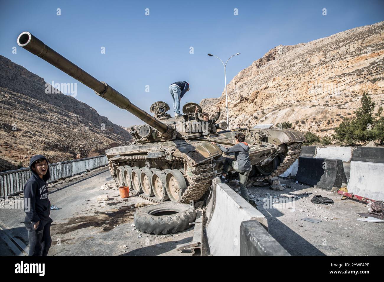 Syria. 10th Dec, 2024. Children play in a tank in Syria, close to the ...