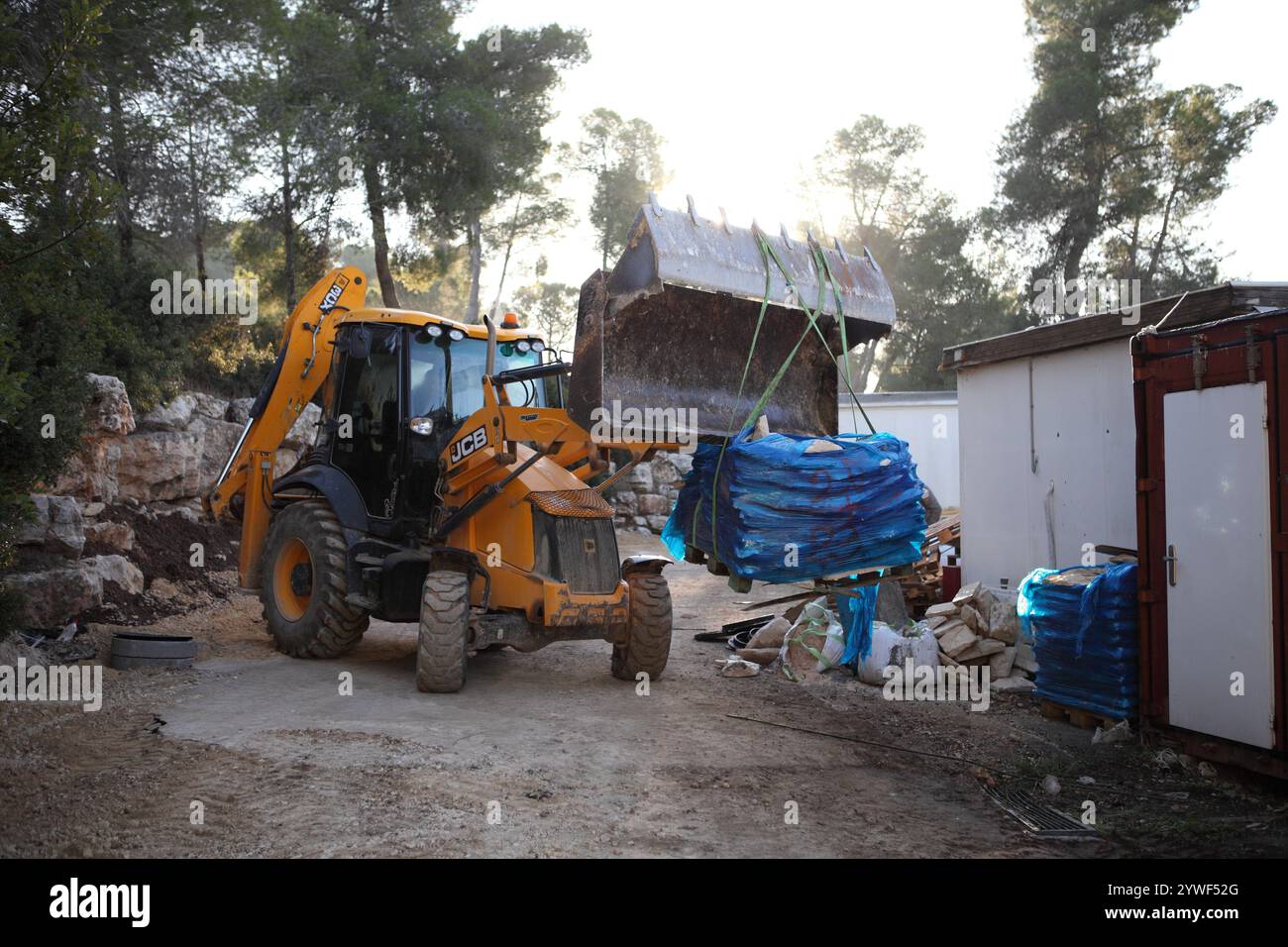 Bulldozer's loader moved by an hydraulic cylindered arm lifting ...