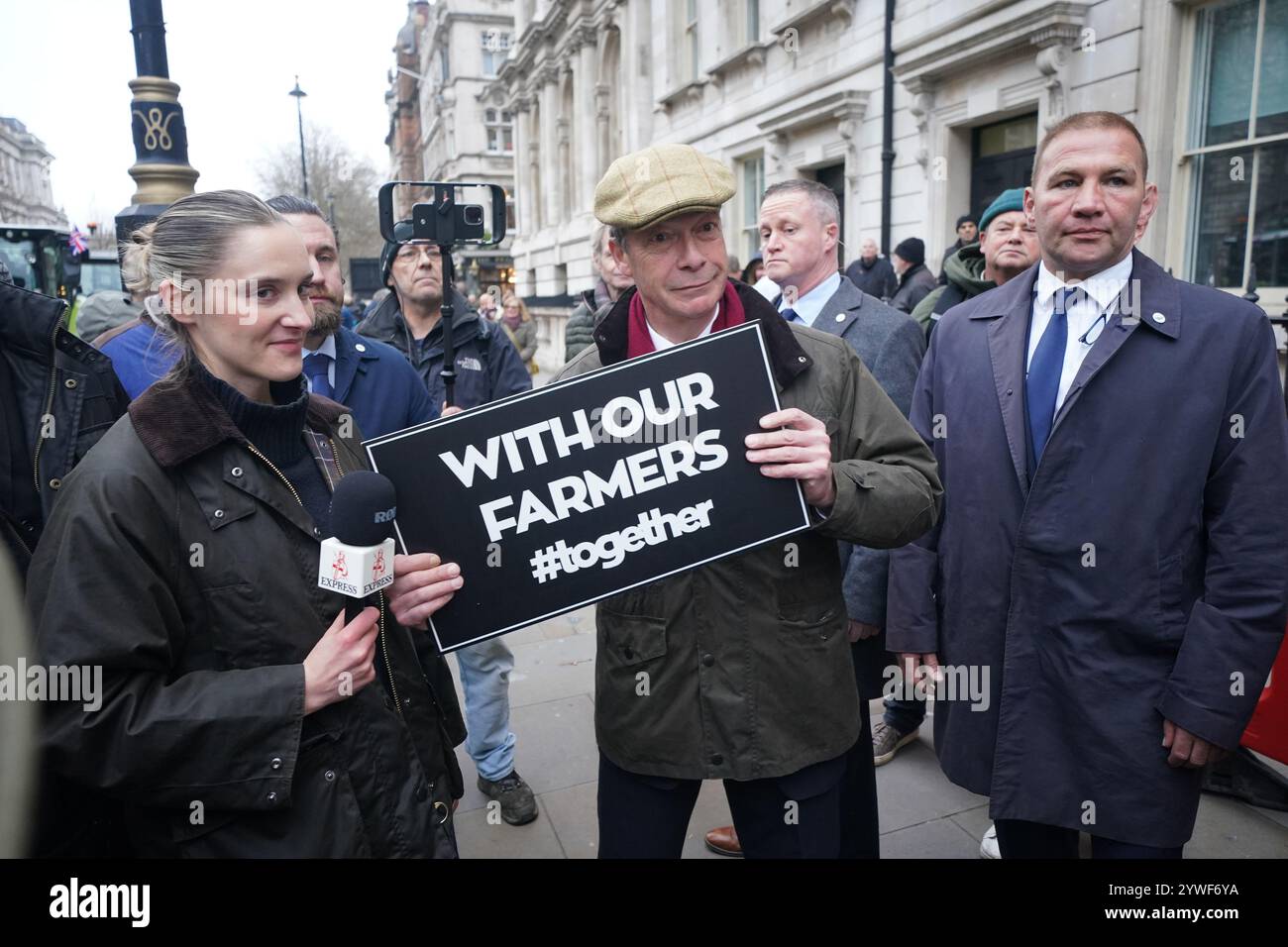 Reform UK leader Nigel Farage holds up a banner during a protest by ...