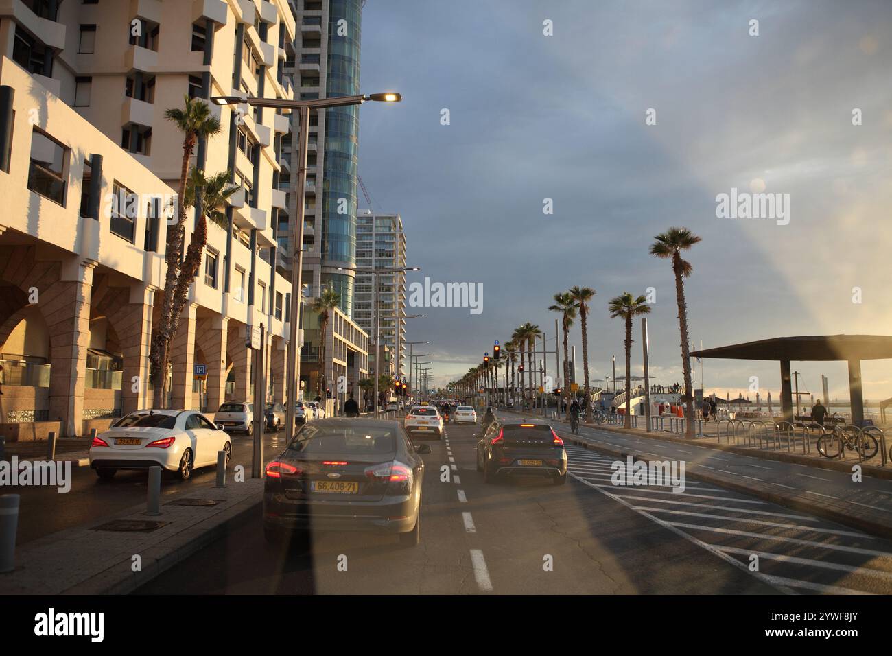 Tel Aviv traffic at sunset. Herbert Samuel St. seen through a car front ...