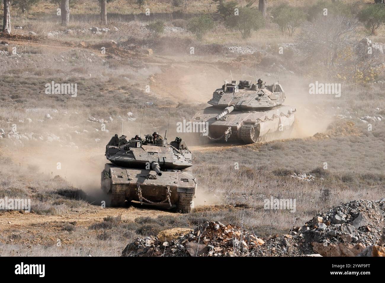 Israeli tanks maneuver next to the security fence near the so-called ...