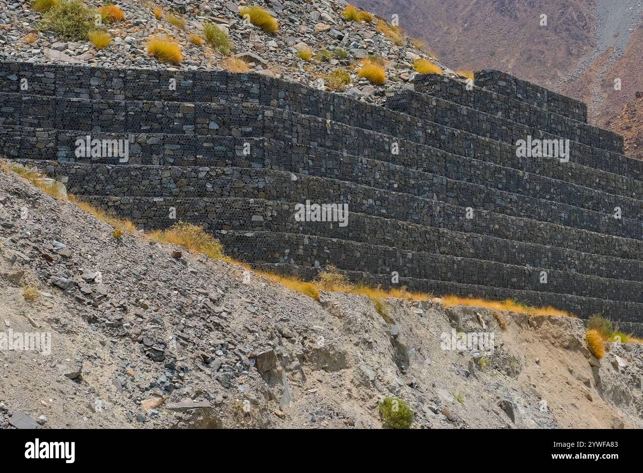 Reinforcing mountain slope with metal mesh and stone blocks, gabion ...