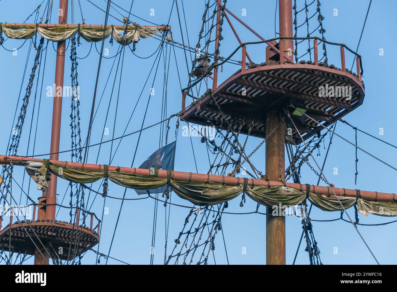 The masts, rigging, and crow's nest of a traditional sailing ship ...