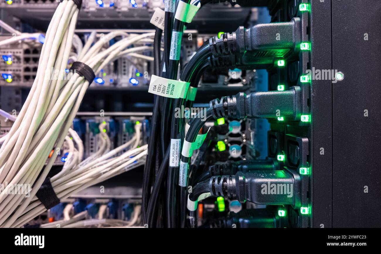 Cables are neatly organized and connected to multiple servers in a data ...