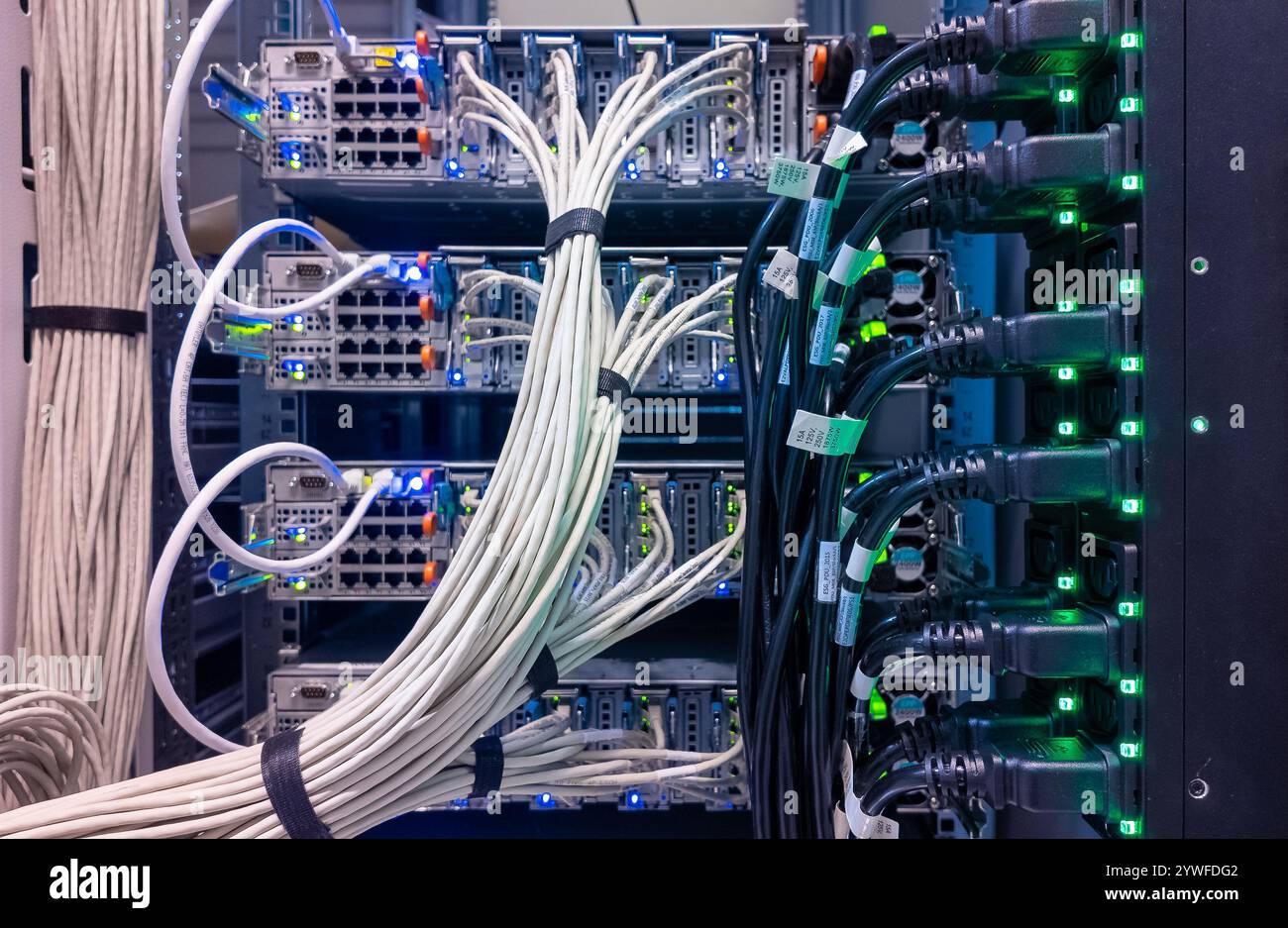 Data center equipment organized with multiple cables connected to ...