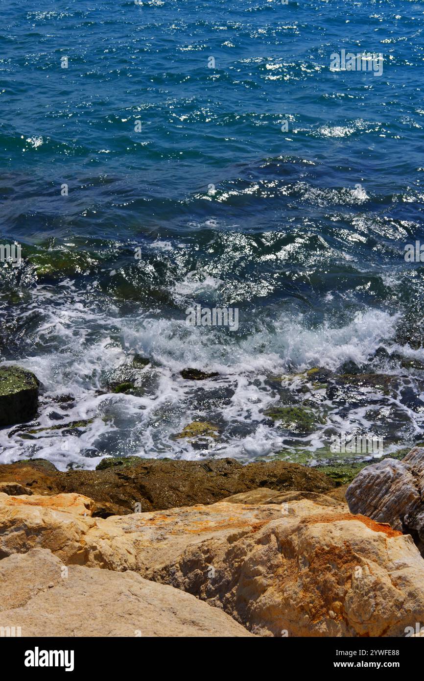 Waves hitting the wet rocks at seashore Stock Photo - Alamy