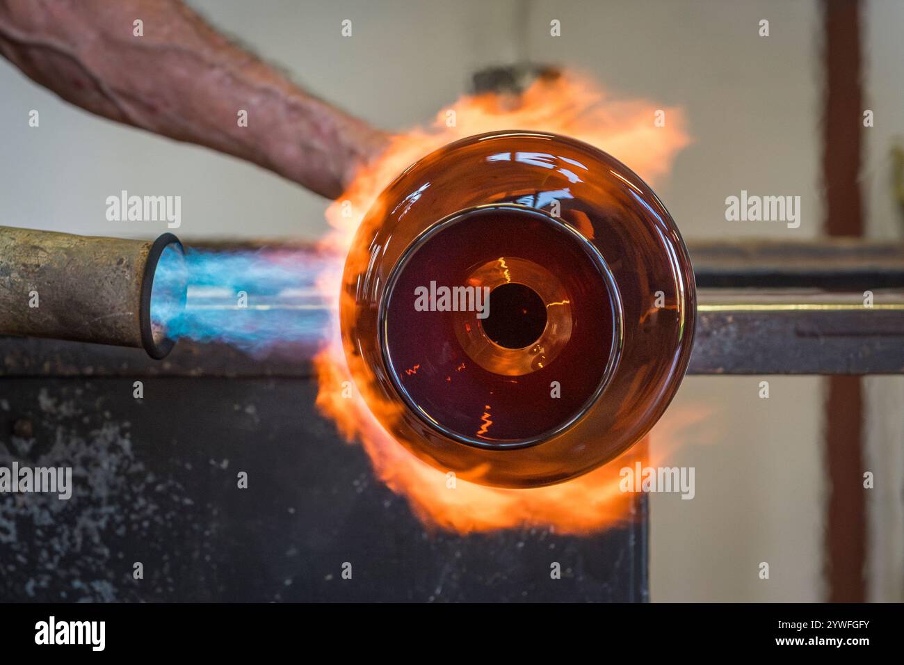 Glassblowing - using a blowtorch to work on a blown glass vase (UK ...