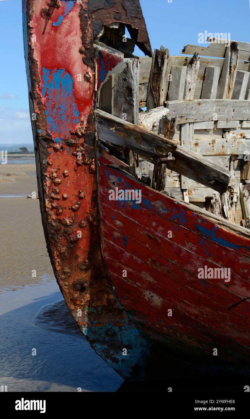 Colourful old fishing boat decaying on a beach Stock Photo - Alamy