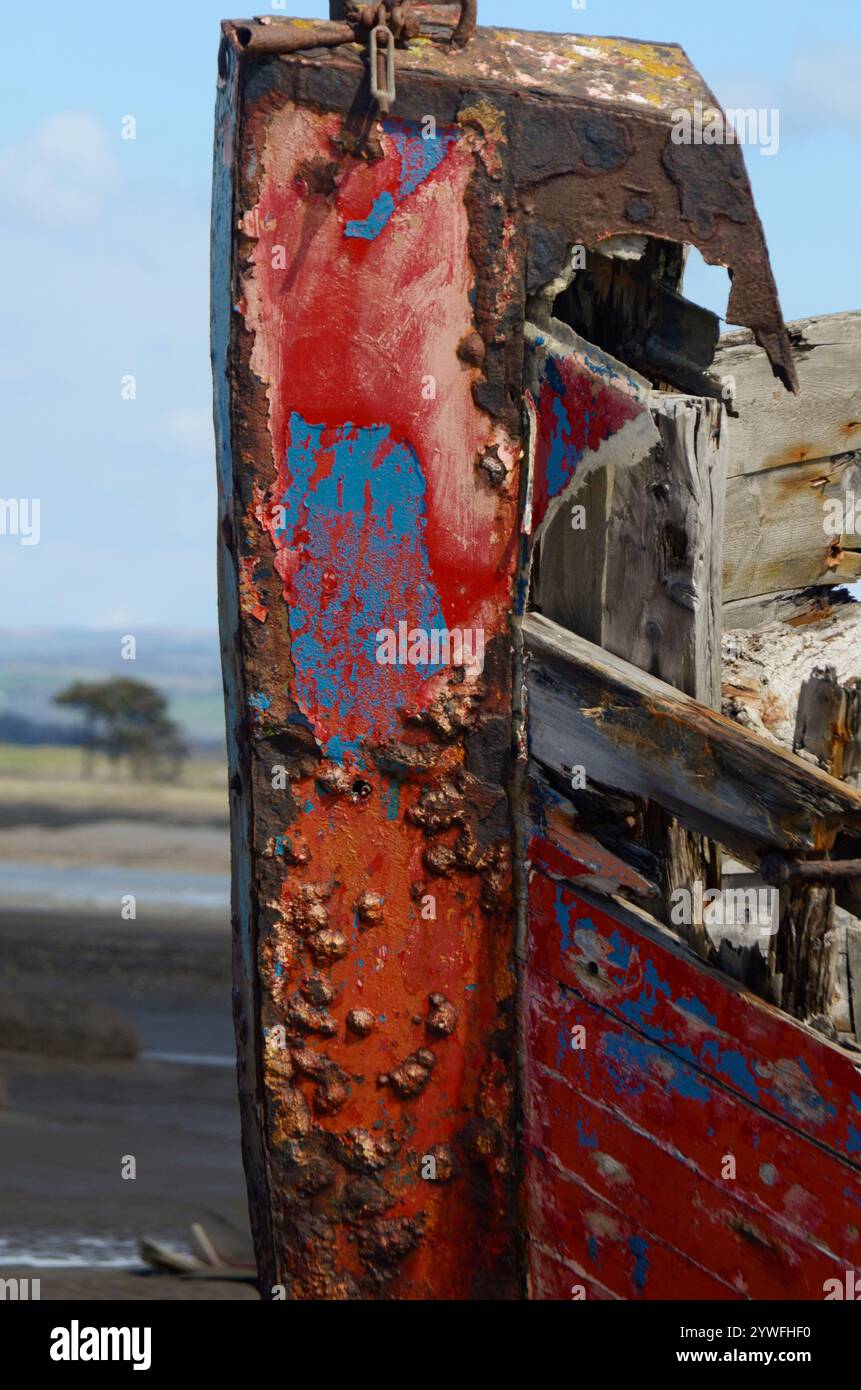 Colourful old fishing boat decaying on a beach Stock Photo - Alamy