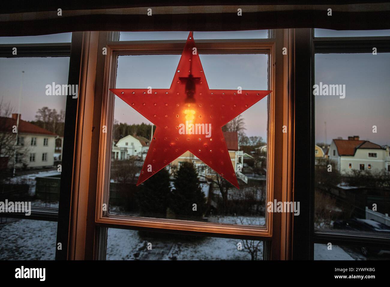 Electric Advent star christmas decorations in window with snow outside ...