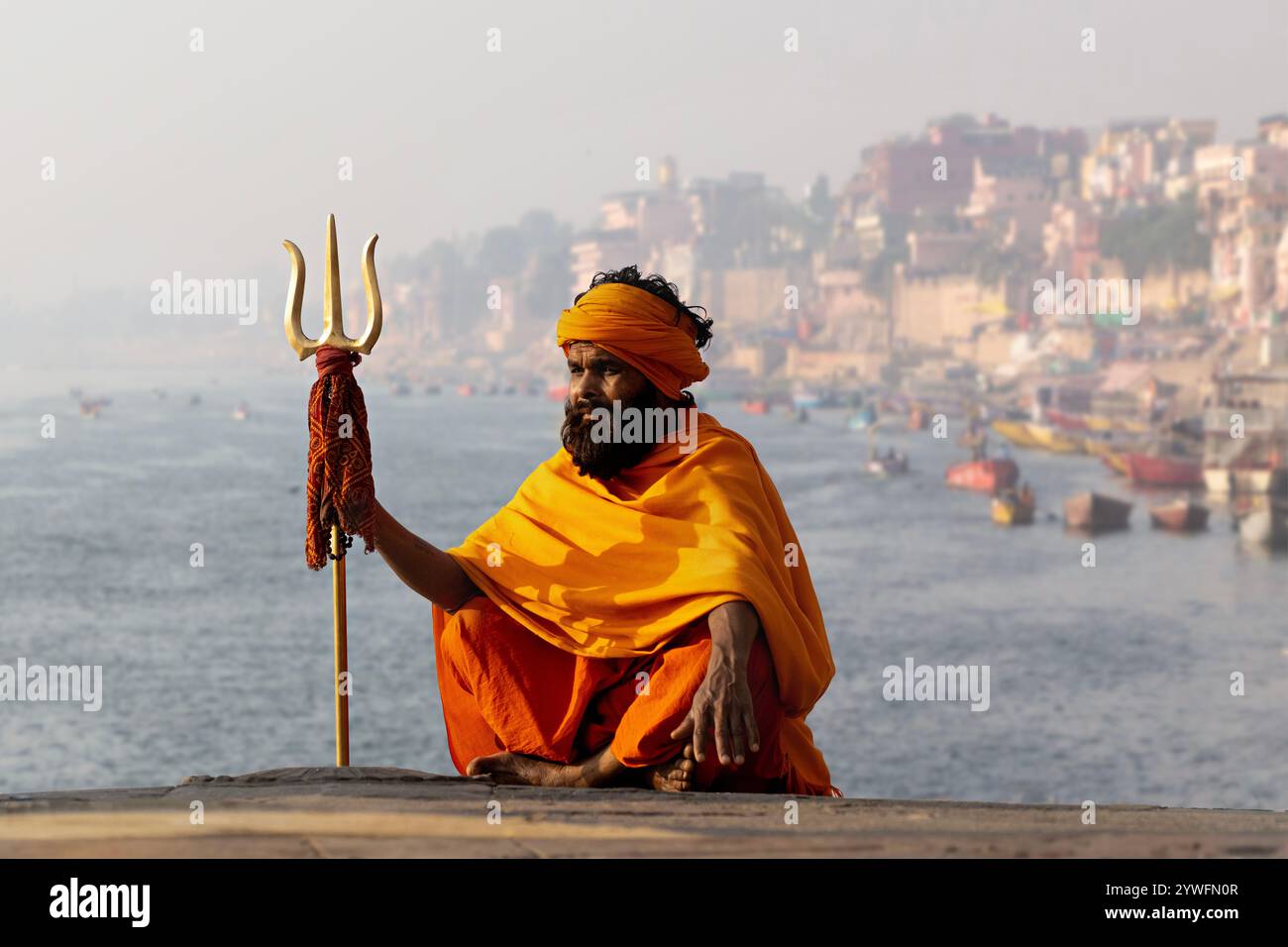 Hindu holy man with the trident of Hindu God Shiva with the River ...