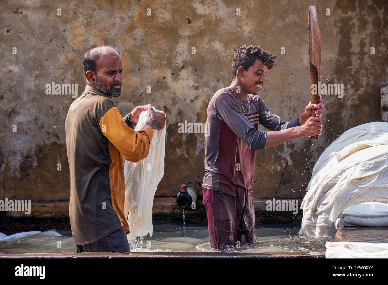 Two dying workers washing cotton fabrics, Gujarat, India Stock Photo ...