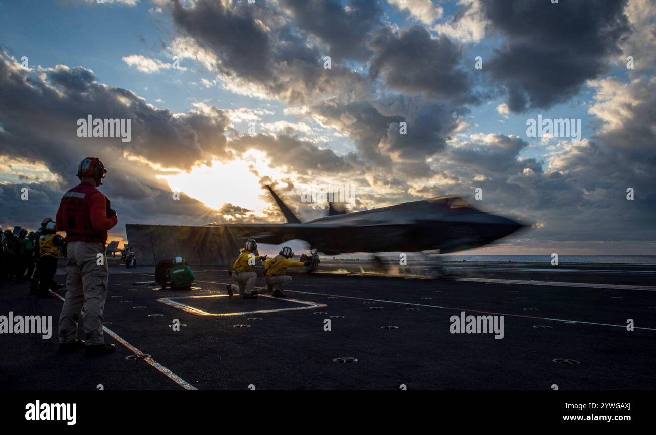 241209-N-FS097-1110 PHILIPPINE SEA (Dec. 9, 2024) – Sailors signal an F-35C Lightning II ...
