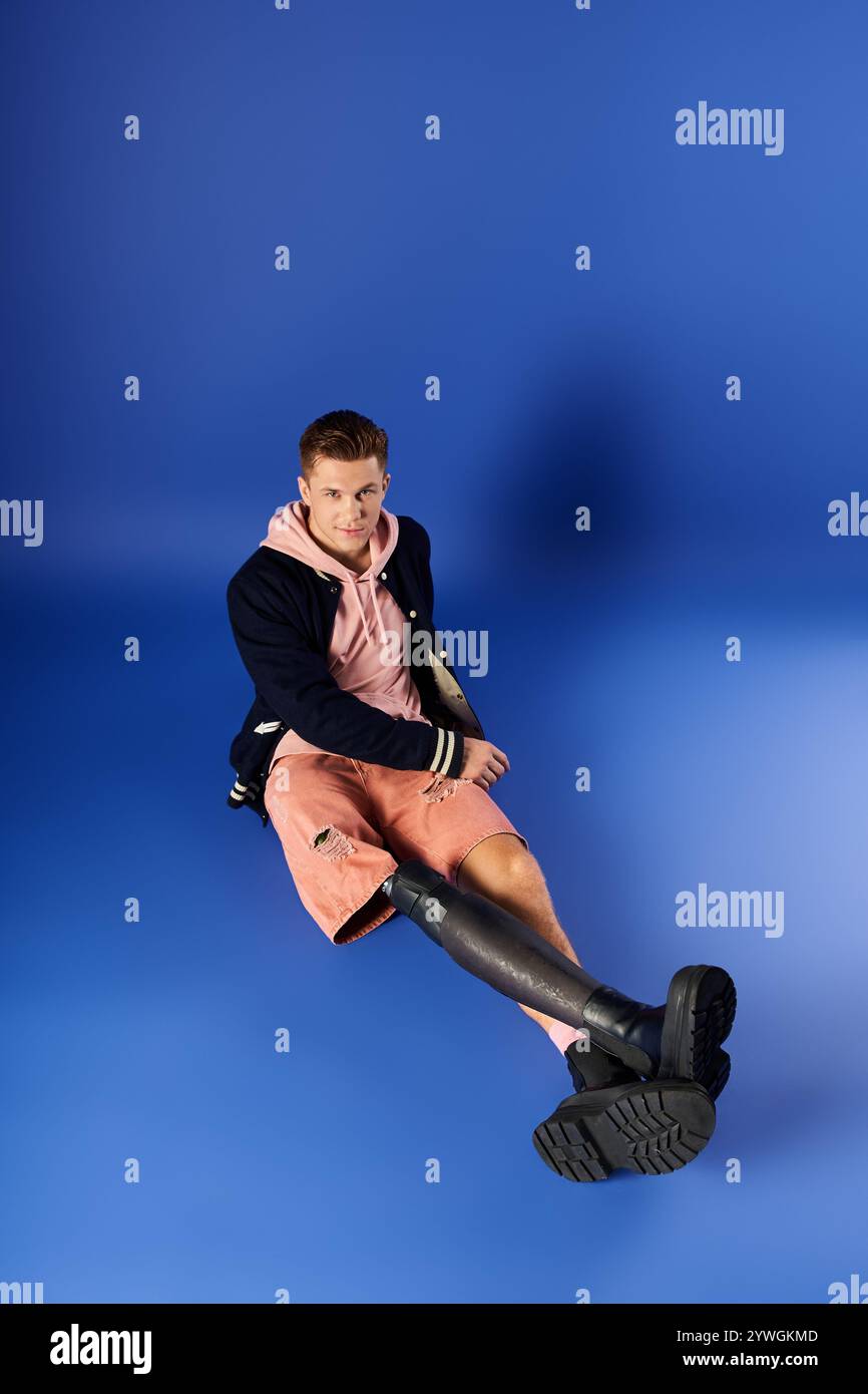 Young man confidently displays his prosthetic leg while seated on a ...