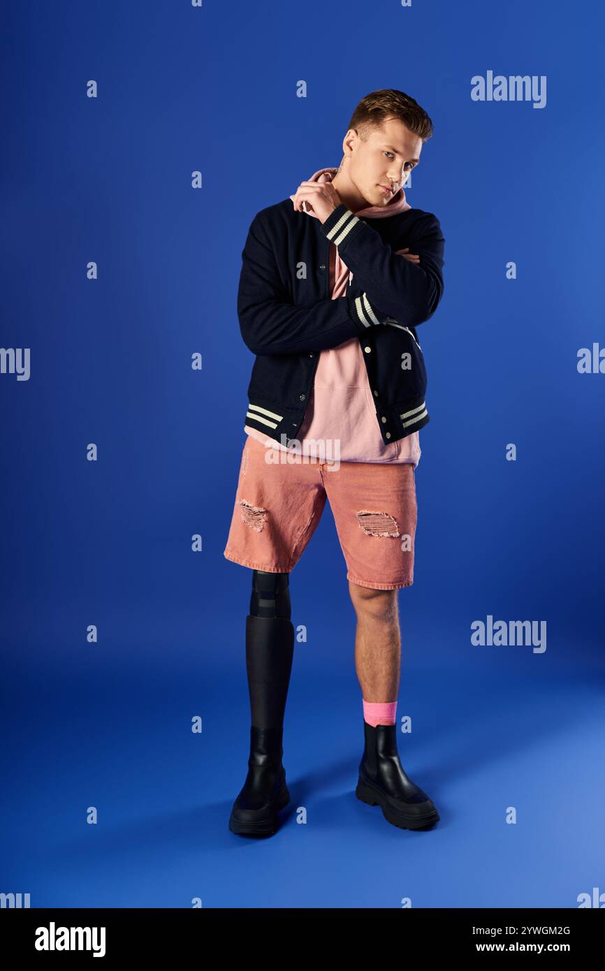 Young man showcases his stylish outfit and confidence while standing ...