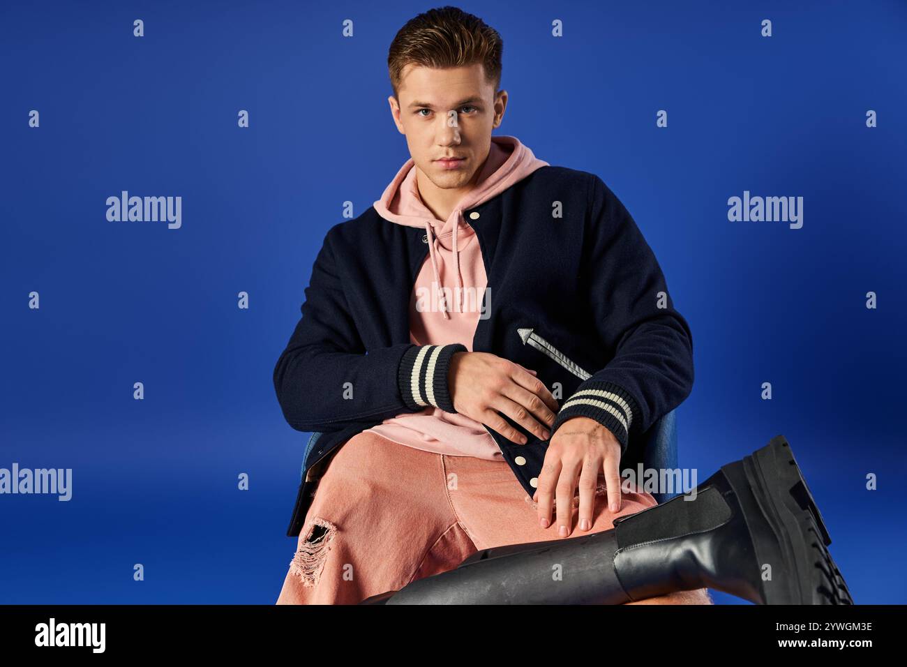 A confident young man showcases his stylish outfit while highlighting ...