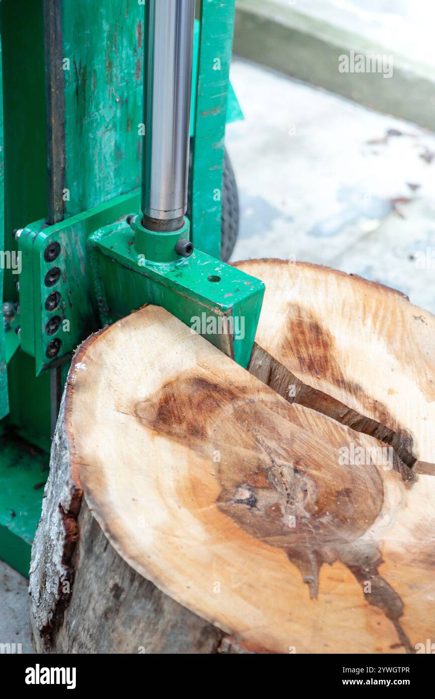 Hydraulic wood chopper splitting a big tree stump Stock Photo - Alamy