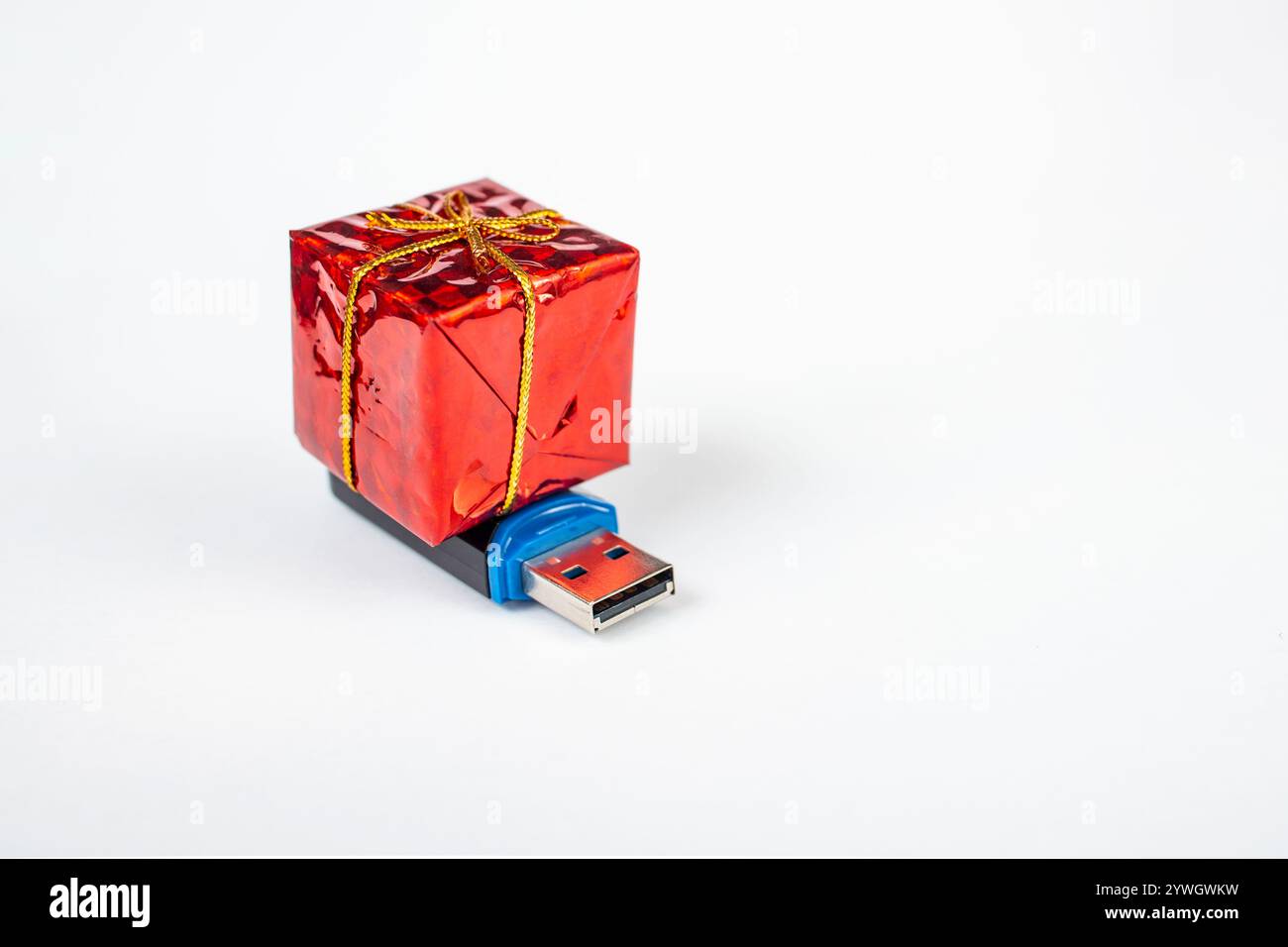 Wrapped red gift box on a usb flash drive, isolated on white background ...