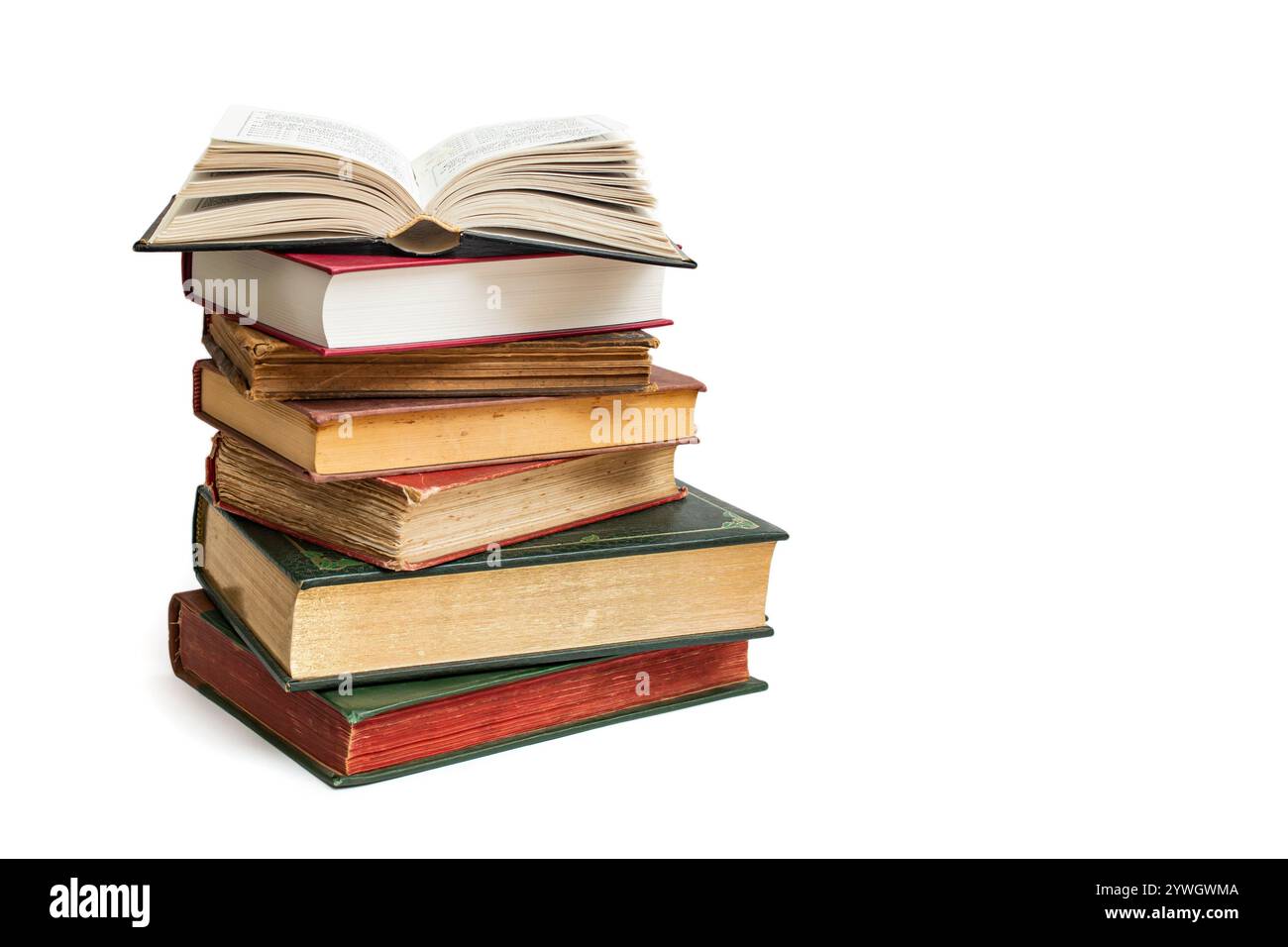 Vintage hard cover books stacked with an opened book on top, isolated ...