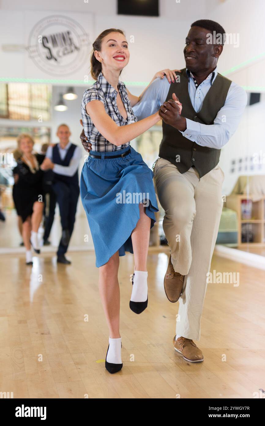 Man and woman performing jazz dance in dancing room Stock Photo - Alamy