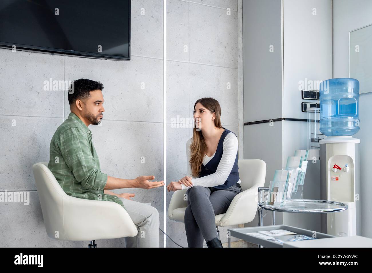Two business people having a conversation in a modern office ...