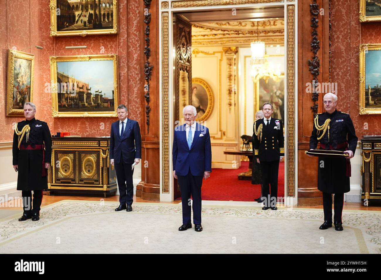 Britain's King Charles III, centre, stands for the national anthem ...