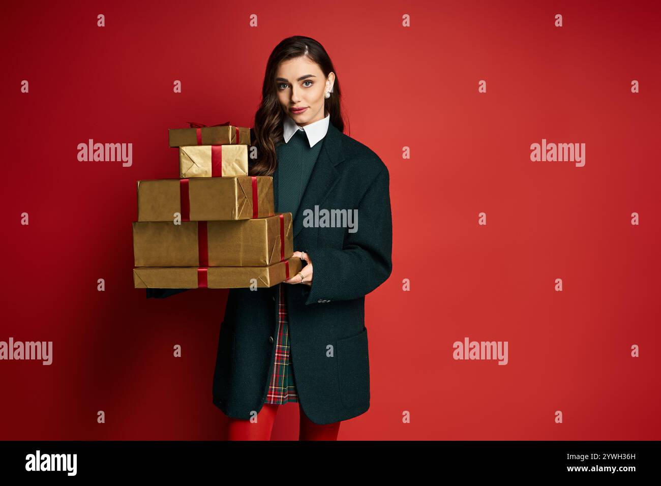 Stylish young woman showcases beautifully wrapped gift boxes in a chic ...