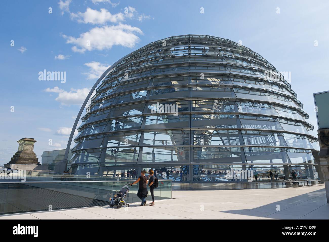 Glass dome of the Reichstag building with visitors in sunny weather ...