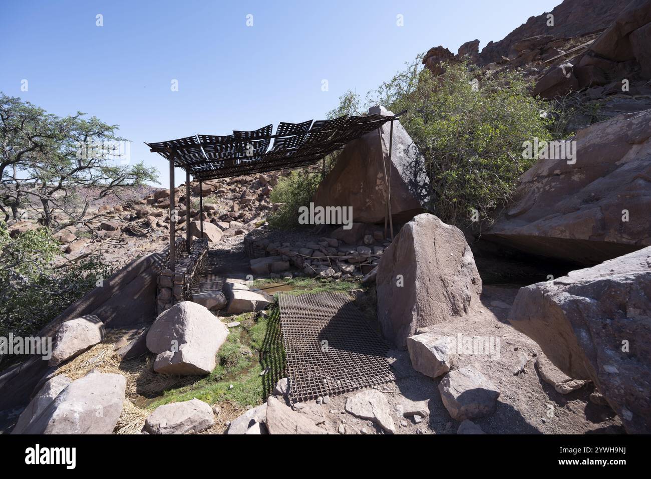 Covered water source Twyfelfontein, Barren landscape with boulders in a ...