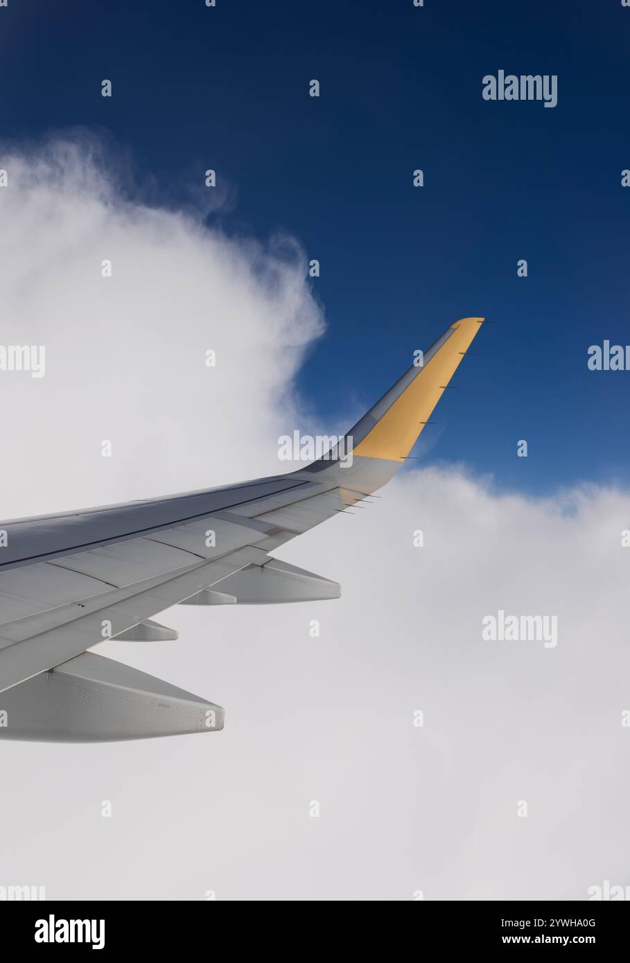 A high resolution photo of a plane wing and blue sky viewed through an ...