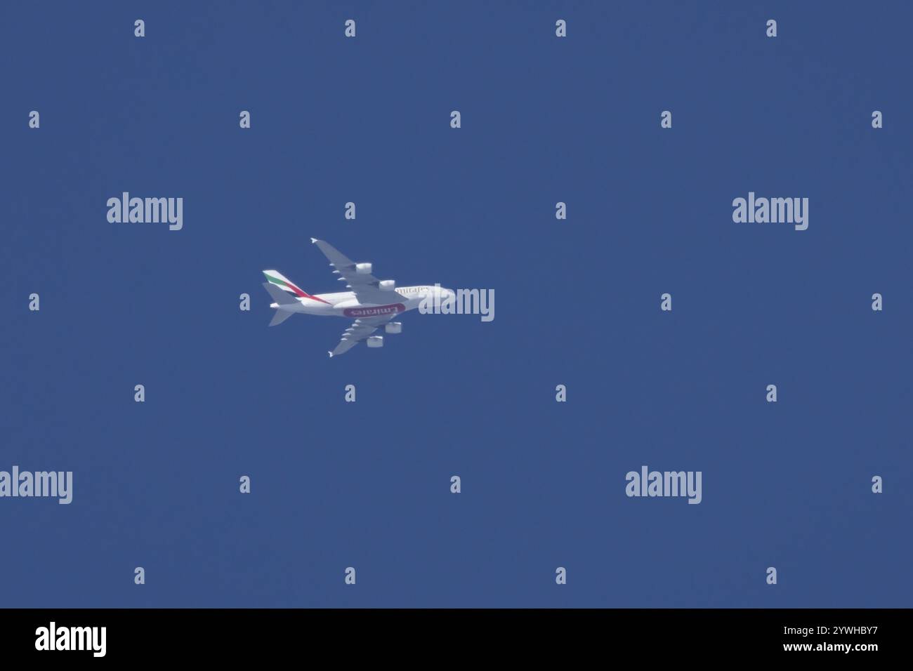 Airbus A380 jet aircraft of Emirates airlines flying in a blue sky ...