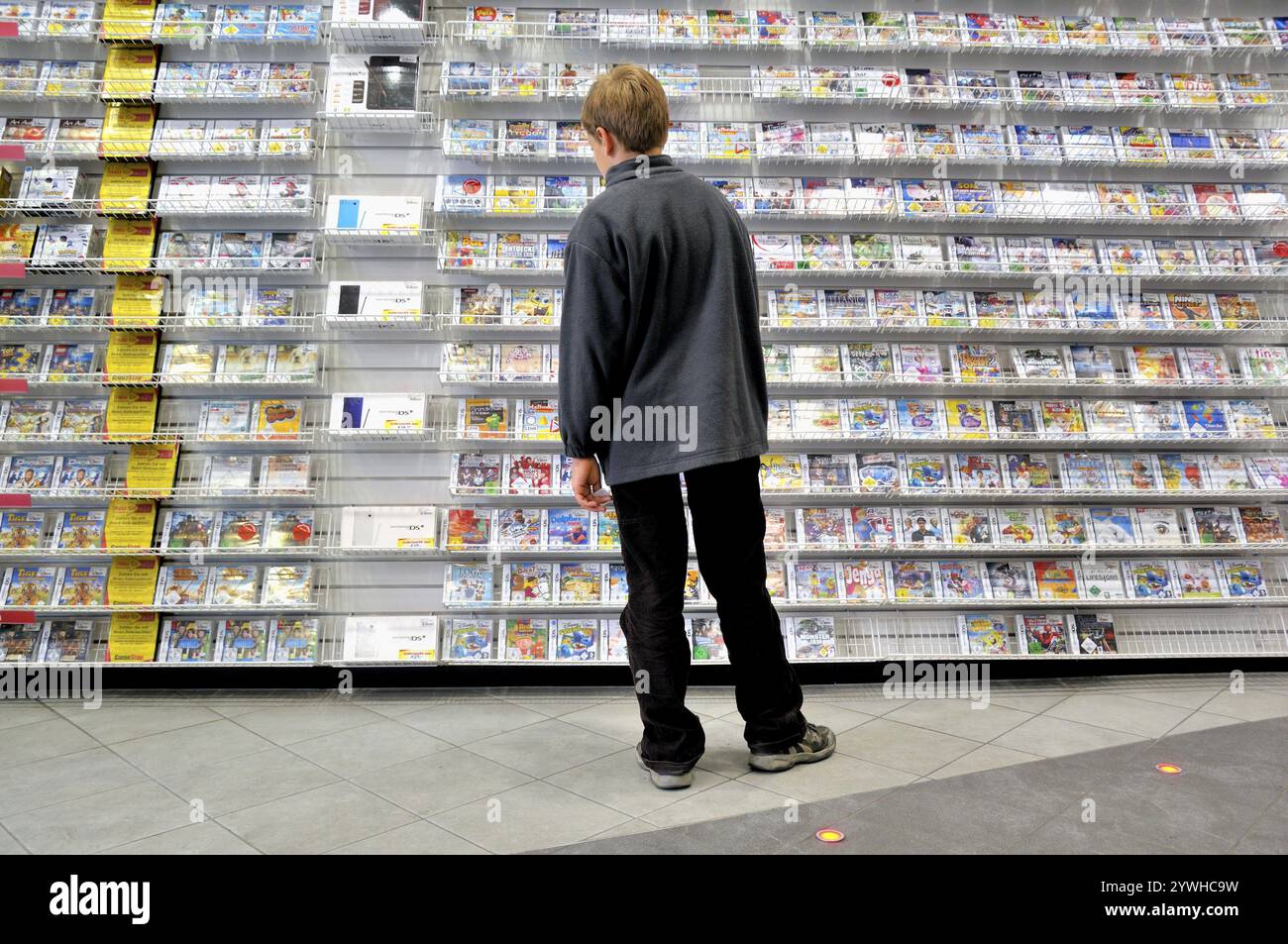 Ten-year-old boy in a shop with a surplus of Nintendo DS games, Germany ...